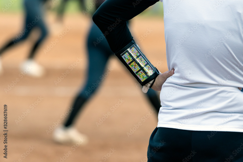 Third base coach for fast pitch softball team wears strategic offensive ...