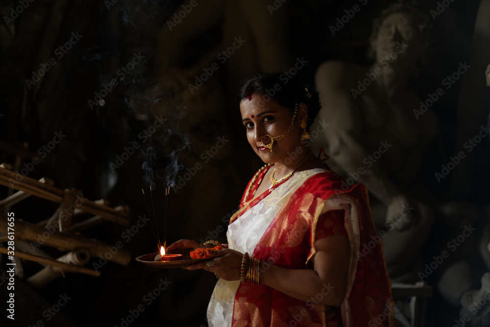 An young and beautiful Indian Bengali brunette woman in red white ...