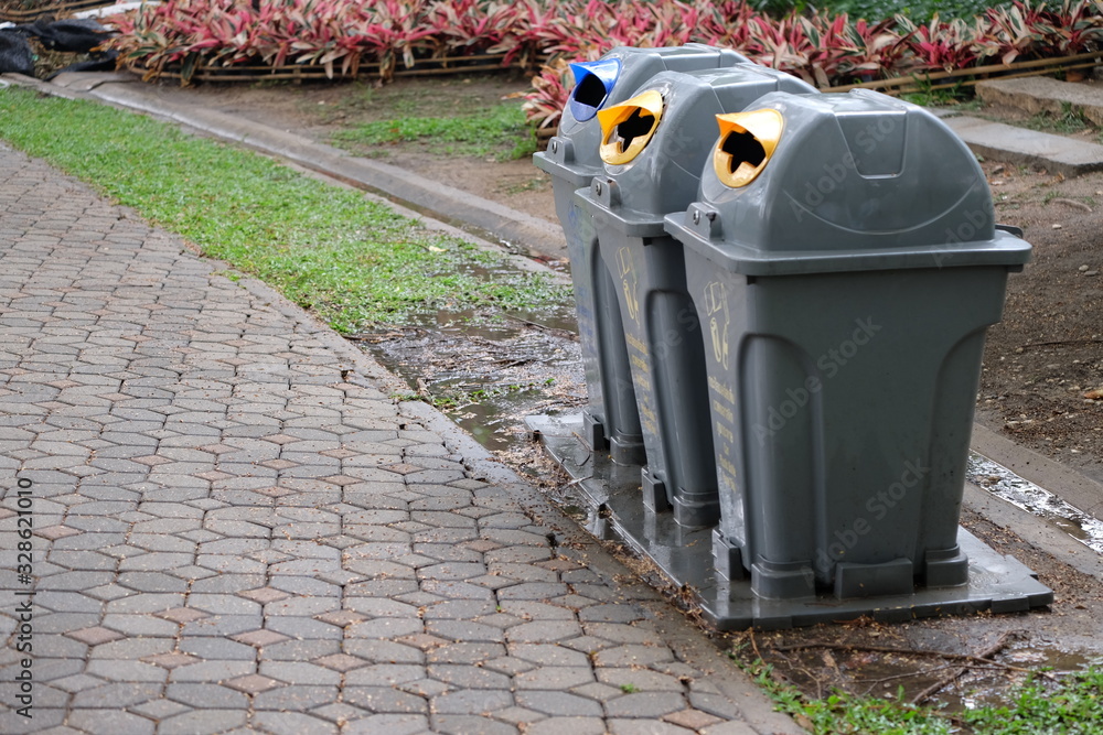 Plastic bins are placed in the park so people can use the service ...