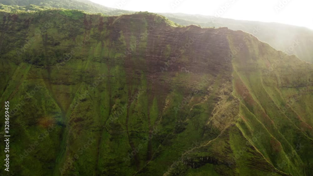 Hawaii. The view of high flat wall of mountain ravine dramatically ...