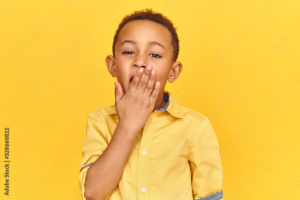 Body language. Cute charming African pupil having exhausted facial ...