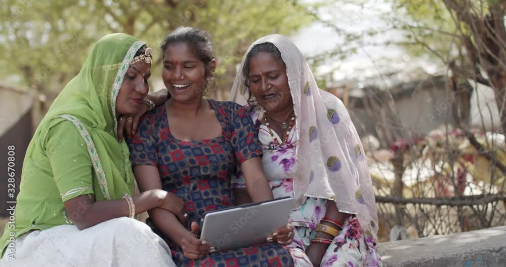 Close-up portrait of three generations of females, wearing traditional ...