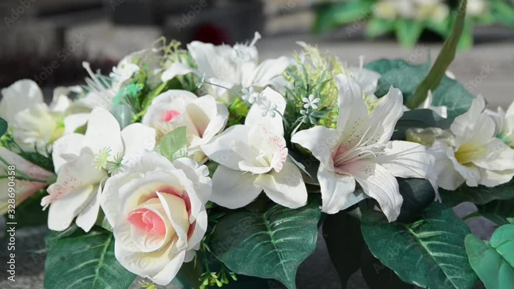 Gravestones and flowers in Catholic Cemetery. Black headstones in ...
