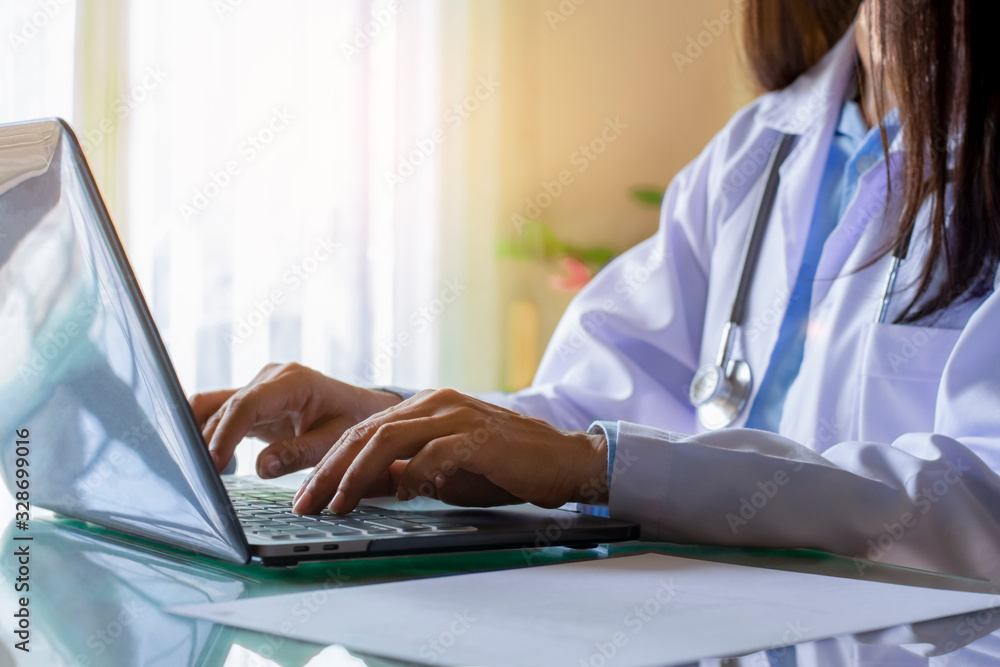 Female doctor or medical student hand using wireless mouse and work on ...