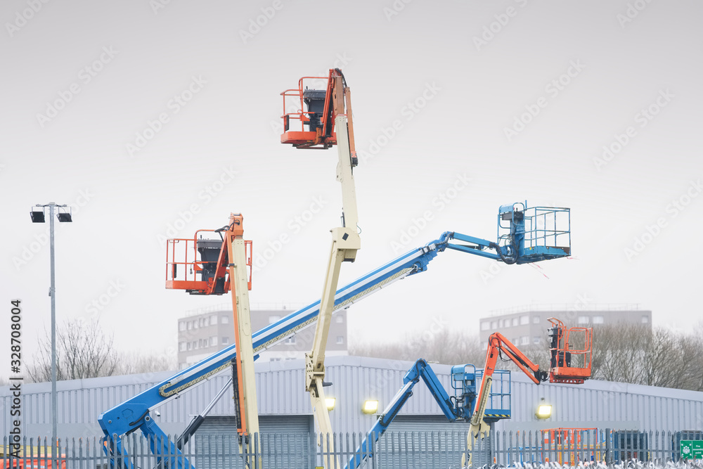 Access platform equipment powered high in sky in blue orange and yellow ...