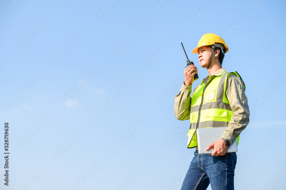 smart asian adult male engineer wearing safety vest and hardhat ...