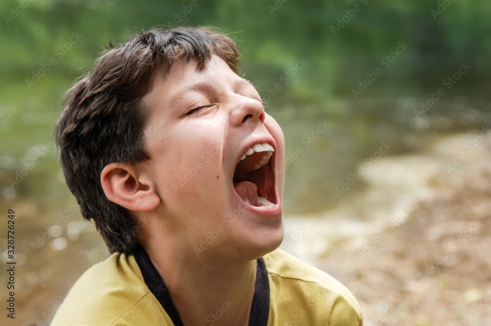 Young boy imagines himself a lion and roars violently like a lion, an ...