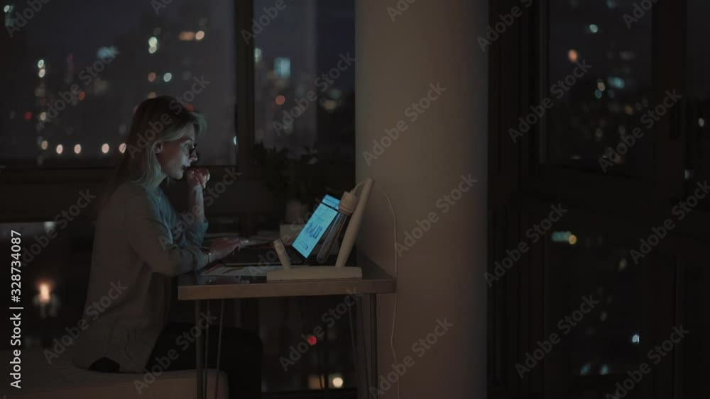 Female freelancer doing overtime distance work on modern laptop ...