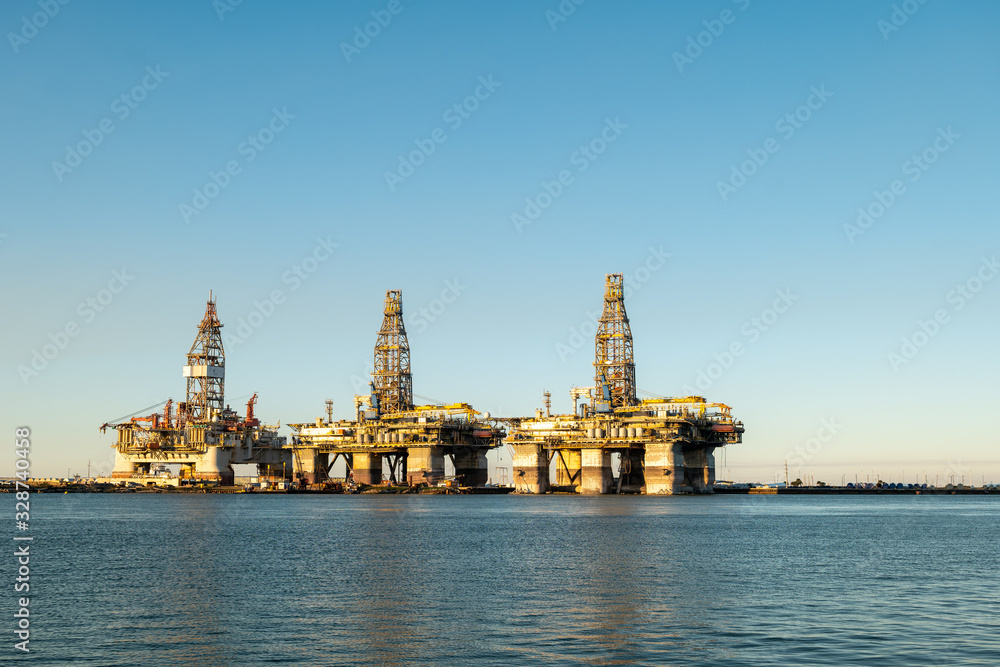 Three offshore oil rig platforms along the shipping channel at Port ...