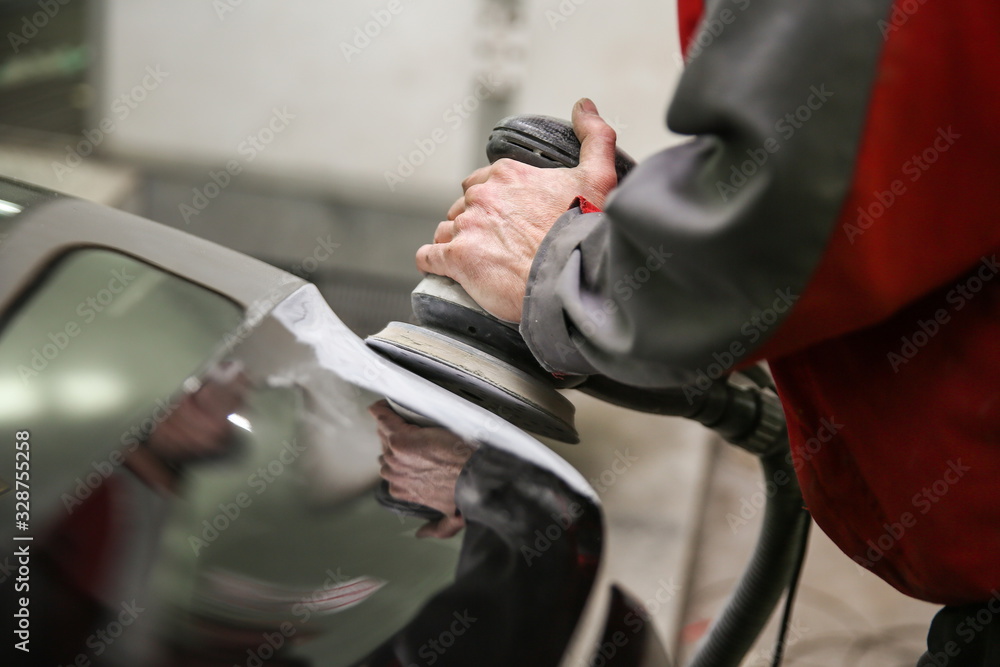 mechanic is sanding car body part by grinding machine Stock Photo ...