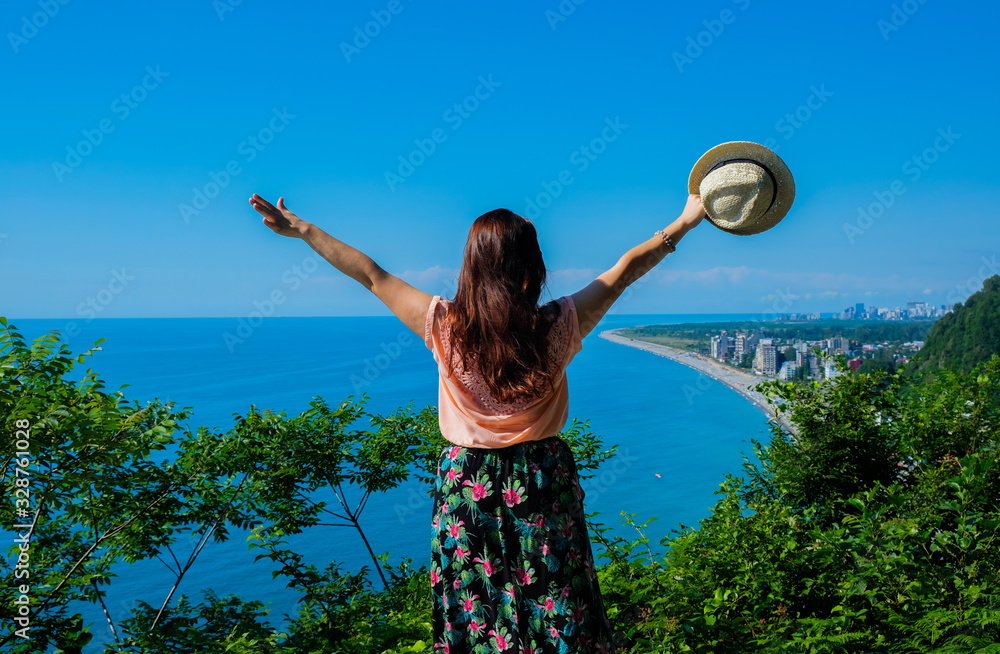 Girl portrait in straw hat, coral blouses and tropical print skirt ...