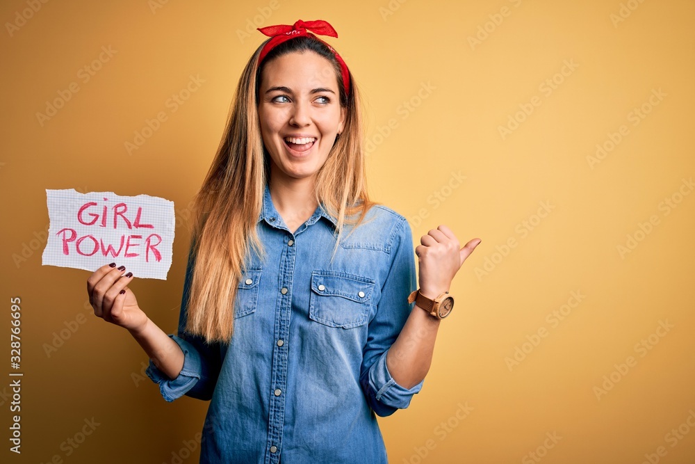 Blonde woman with blue eyes asking for girls rights holding banner with ...