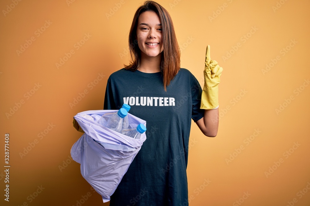 Beautiful volunteer girl caring environment doing volunteering holding ...