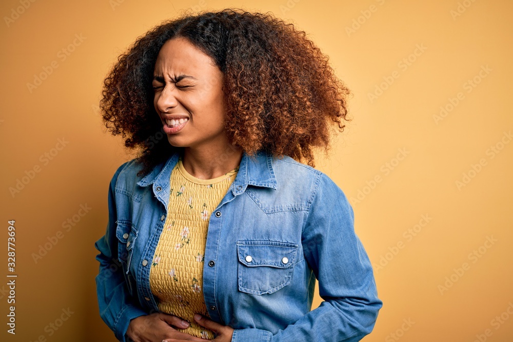 Young african american woman with afro hair wearing casual denim shirt ...