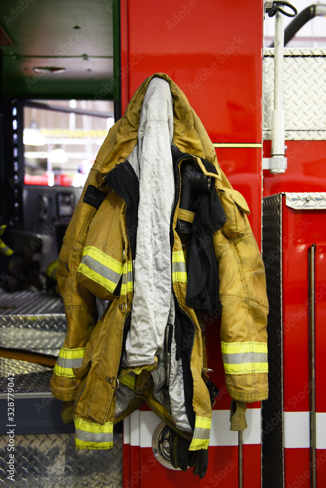 Foto de A Firefighters Coat hanging on the outside of a Fire Engine. do ...
