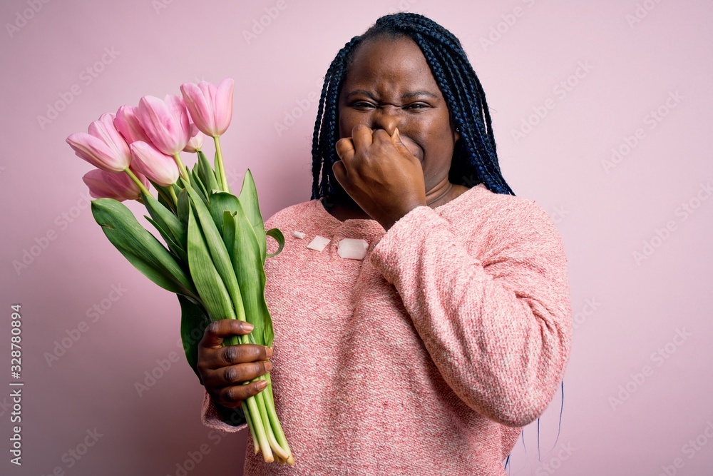 Young african american plus size woman with braids holding bouquet of ...