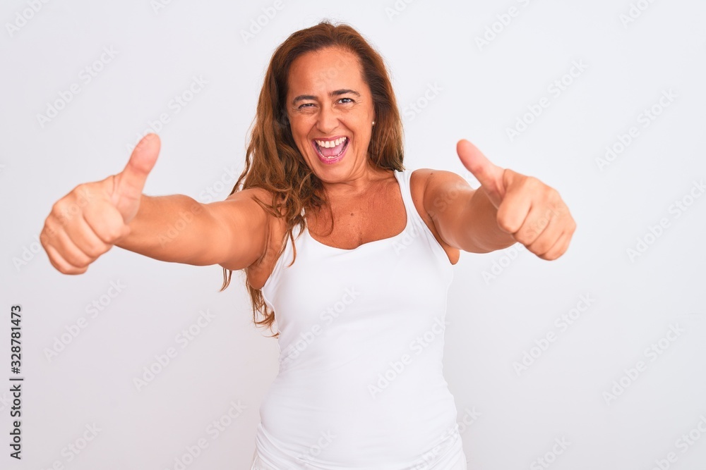 Middle age mature woman standing over white isolated background ...
