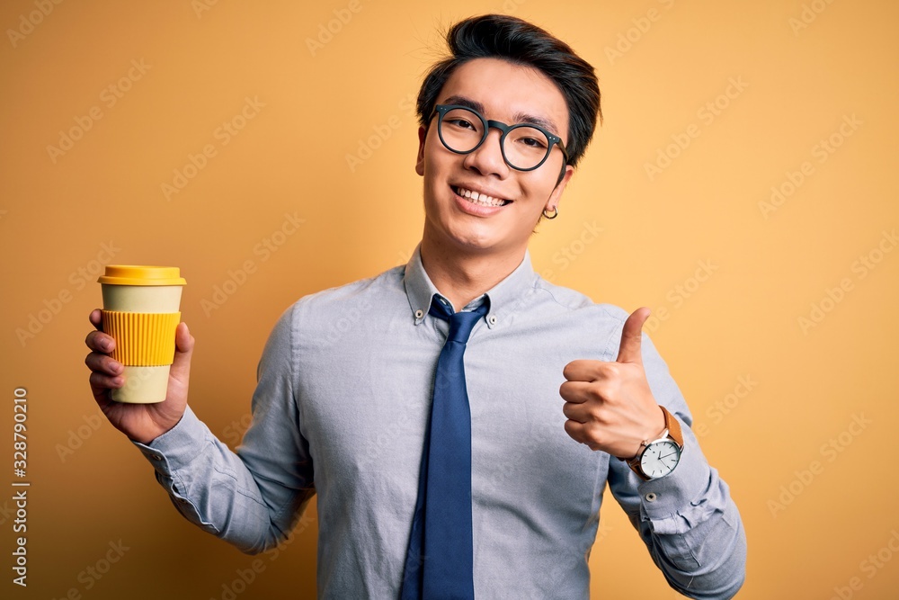 Young handsome chinese man drinking glass of take away coffee over ...