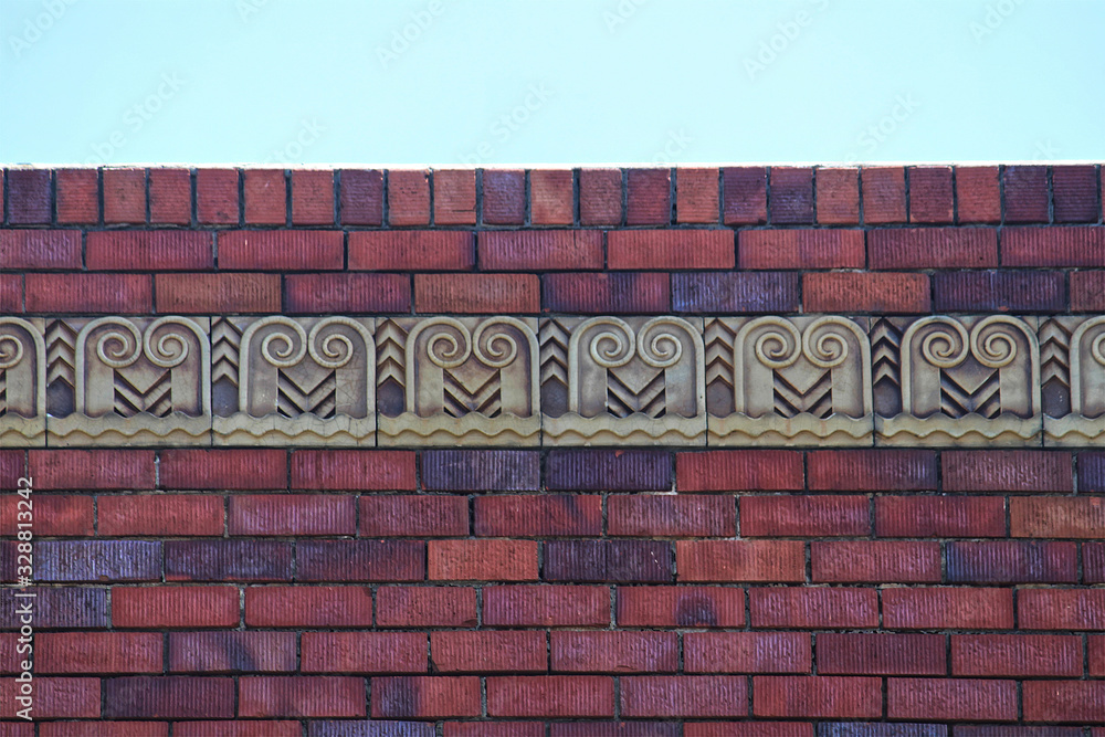 Art Deco architectural border feature on the facade of an old pub. Red ...