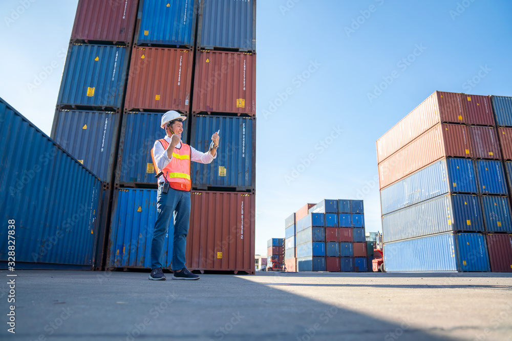Logistics engineer control at the port, loading containers for trucks ...