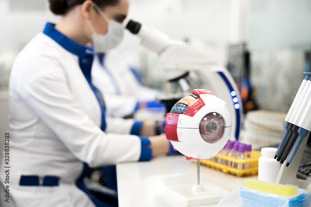 Enlarged human eye model and laboratory samplers Stock Photo | Adobe Stock