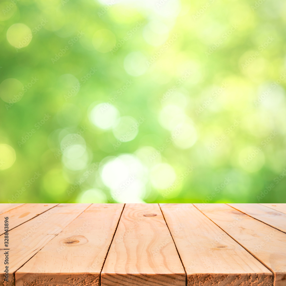 Real wood table top texture on blur leaf tree garden background.For ...