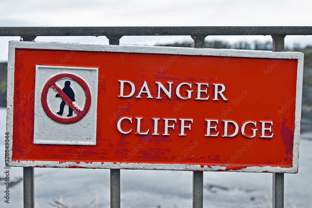 Authentic sign for danger cliff edge with icon of person walking ...