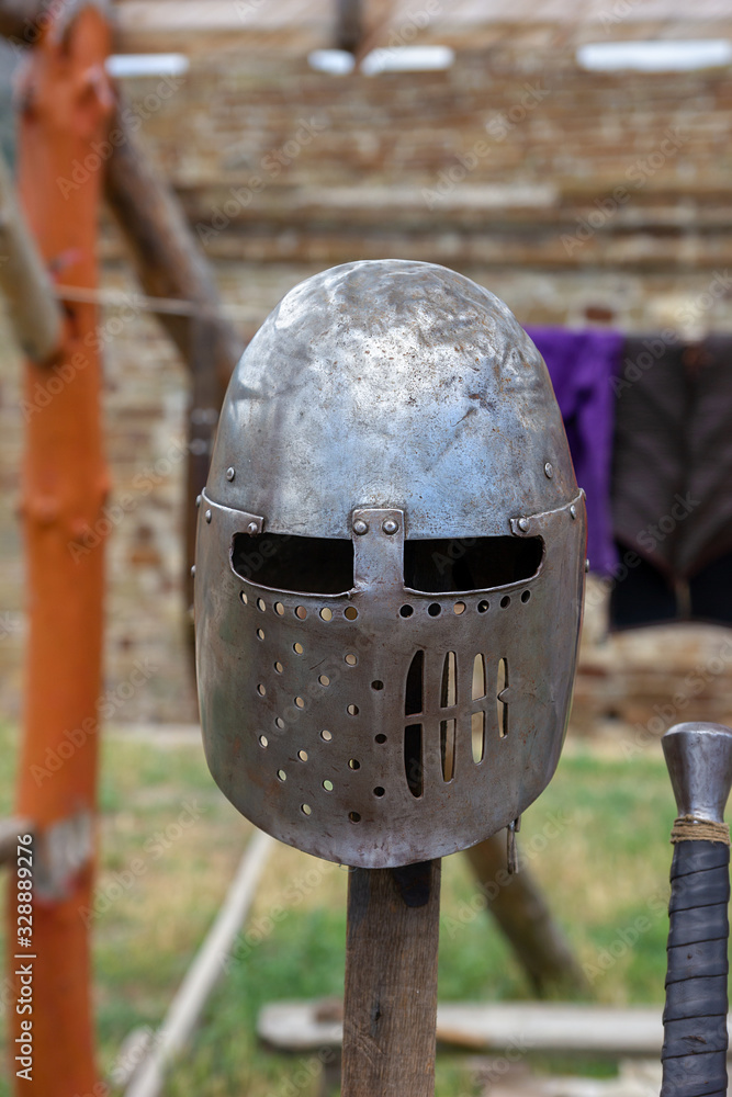 The antique knight's helmet on a mannequin on the background of an ...