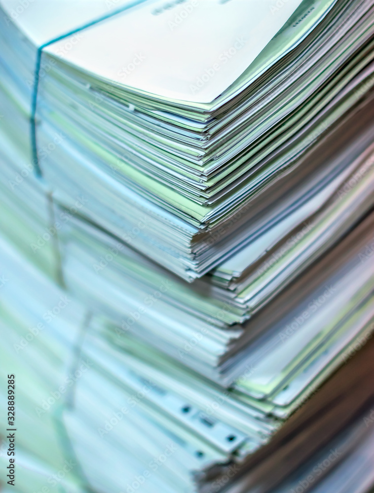 bundles bales of paper documents. stacks packs pile on the desk in the ...