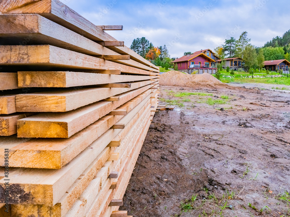 Lumber. Wooden beams are stored outside. Concept - preparation of ...
