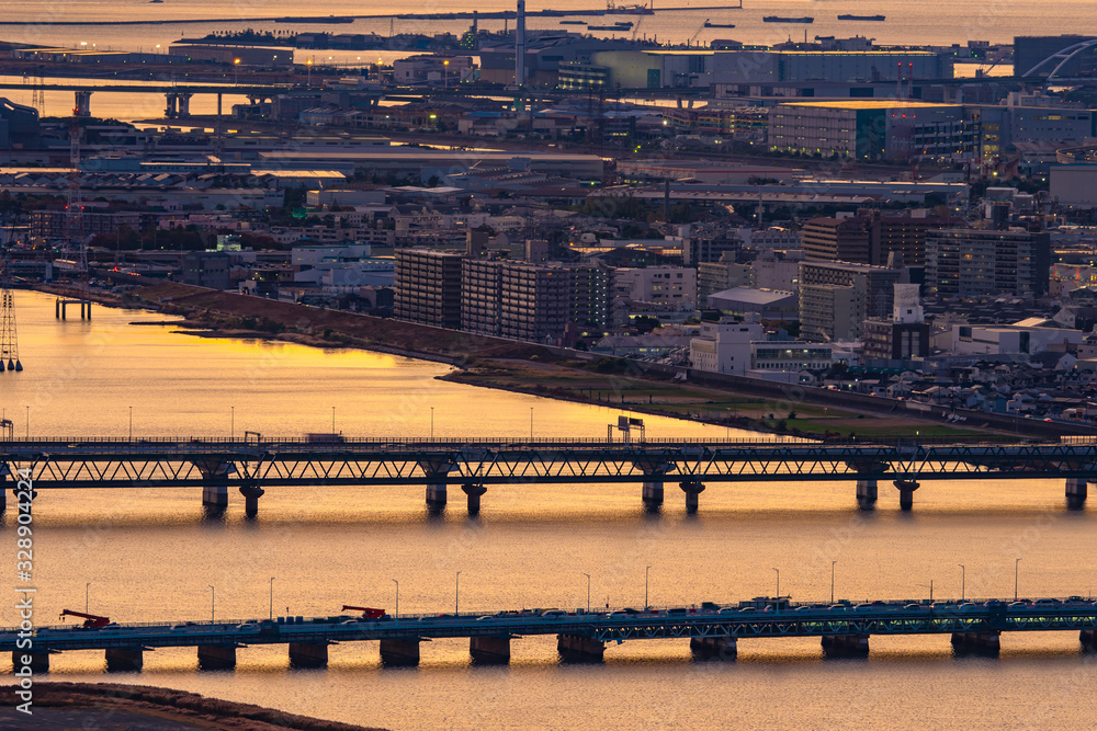 Japan. Osaka. Car bridges over the bay. Railway bridge next to the ...