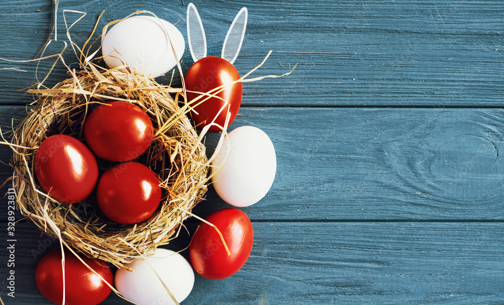 colored deep red Easter eggs in nest top view background, selective ...