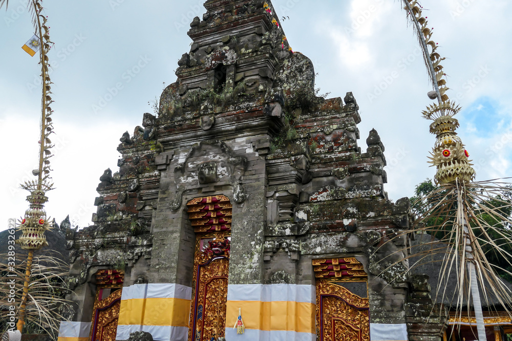 A colorful Hindu Temple on Bali, Indonesia. Main gates are wrapped with ...