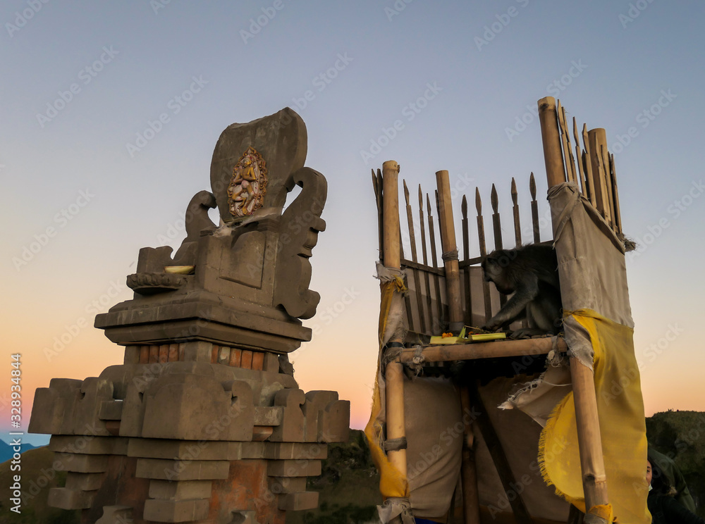 A Hinduism offering altar with a sunset behind it on Bali, Indonesia ...