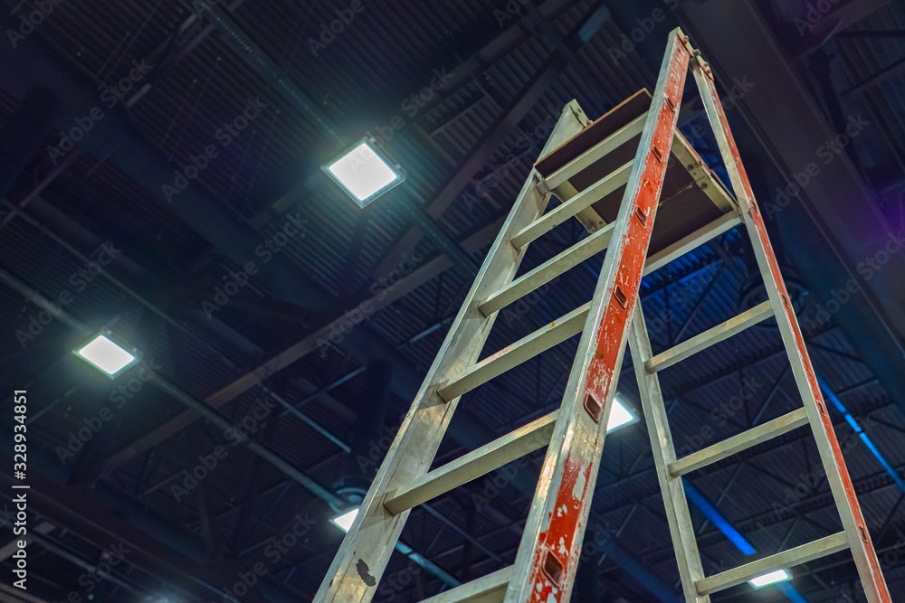 Scaffolding with scuffs. Ladder for installation work inside building ...