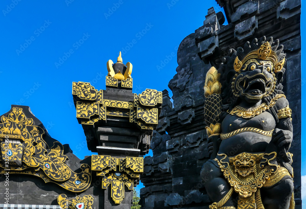 A close up on black and golden entrance gate to Tanah Lot temple on ...
