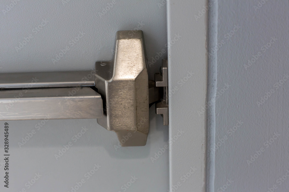 Emergency fire exit door. Closed up latch and rusty door handle of ...