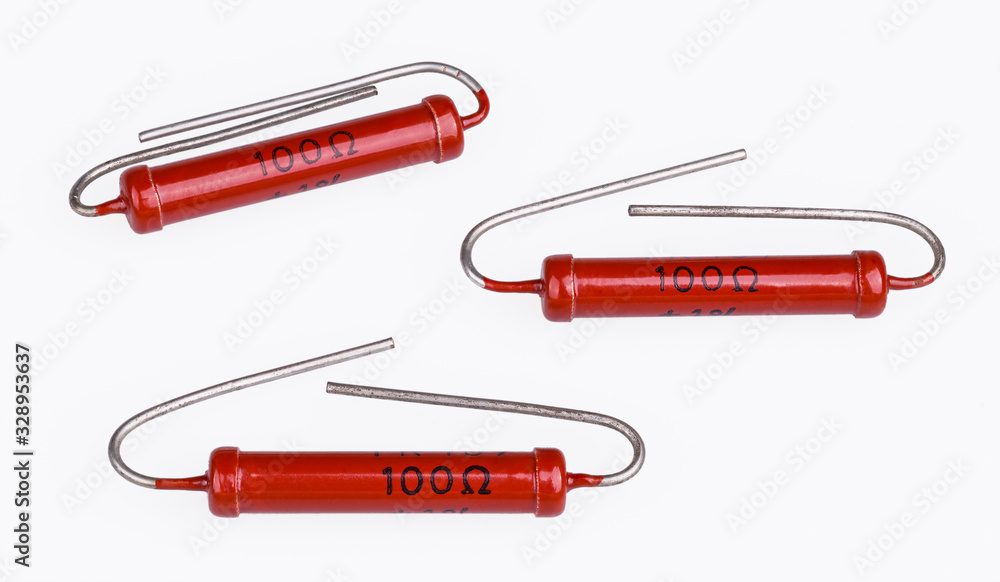 Three cylindrical carbon power resistors with bent lead wires on white ...