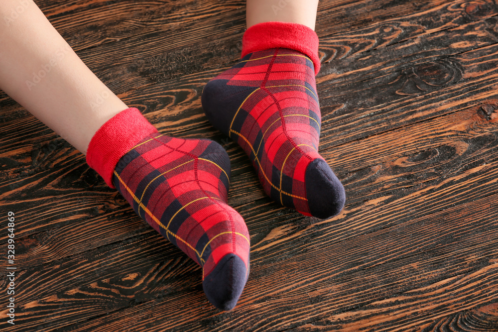 Legs of woman in socks on wooden background Stock Photo | Adobe Stock