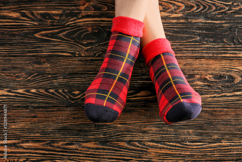 Legs of woman in socks on wooden background Stock Photo | Adobe Stock
