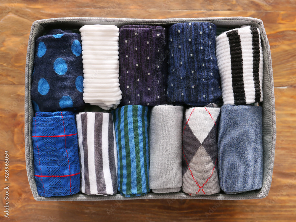Box with different socks on wooden background Stock Photo | Adobe Stock