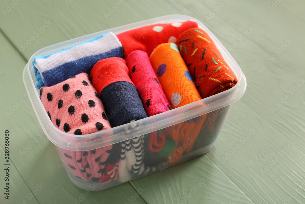 Box with different socks on wooden background Stock Photo | Adobe Stock
