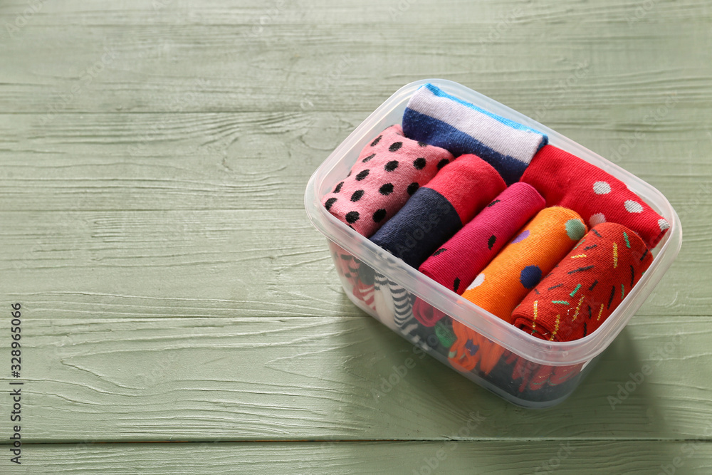 Box with different socks on wooden background Stock Photo | Adobe Stock