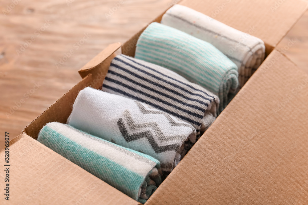 Box with different socks on wooden background, closeup Stock Photo ...