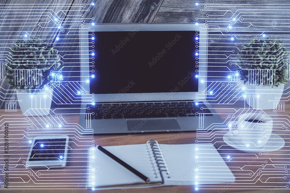 Computer on desktop in office with technology theme hologram. Multi ...