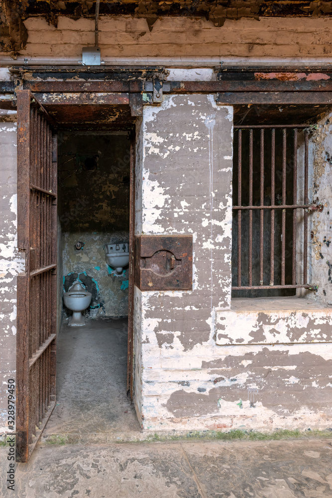 Prison cell with the door open showing the toilet and sink inside ...