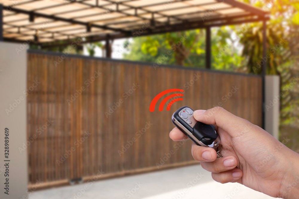 Closeup hand holding and using remote control to open or close the ...