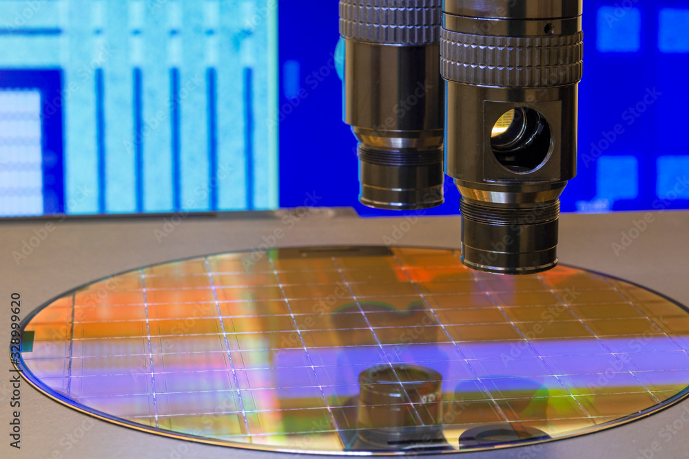 Silicon wafer with semiconductor microchip on machine process examining ...