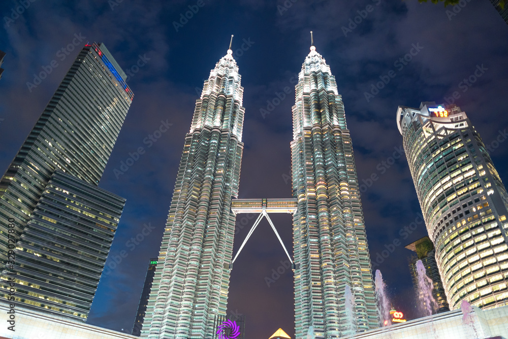 Night picture of illuminated Petronas Twin Towers with an ensemble of ...