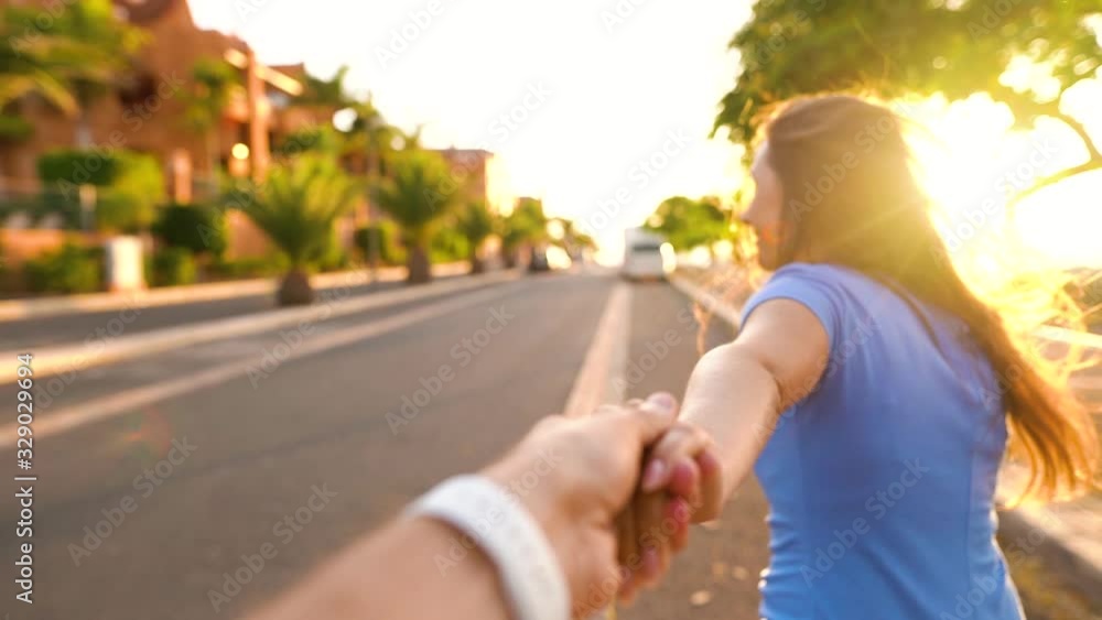 Follow me - happy young woman pulling guy's hand - hand in hand running ...